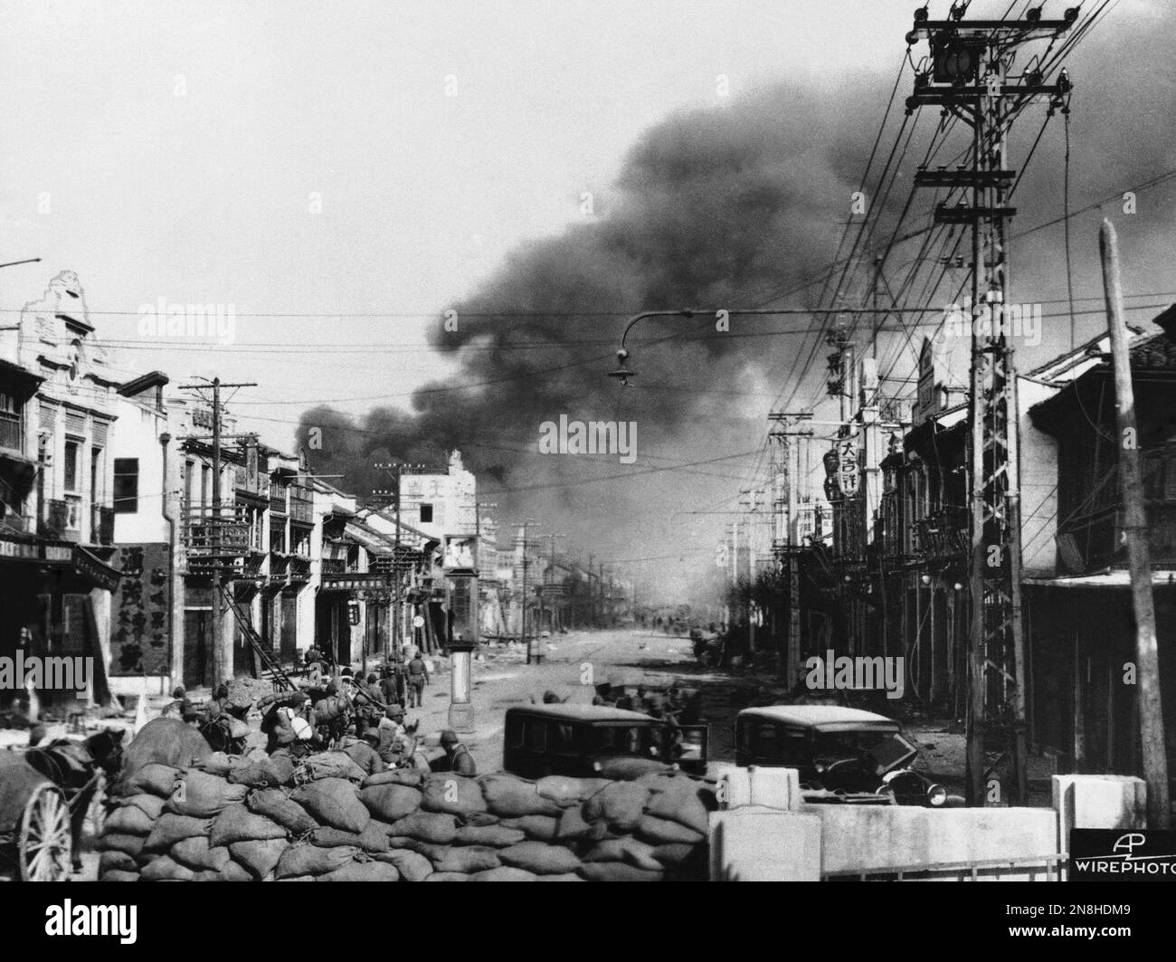 Streets piled high with sandbags and littered with debris greeted ...
