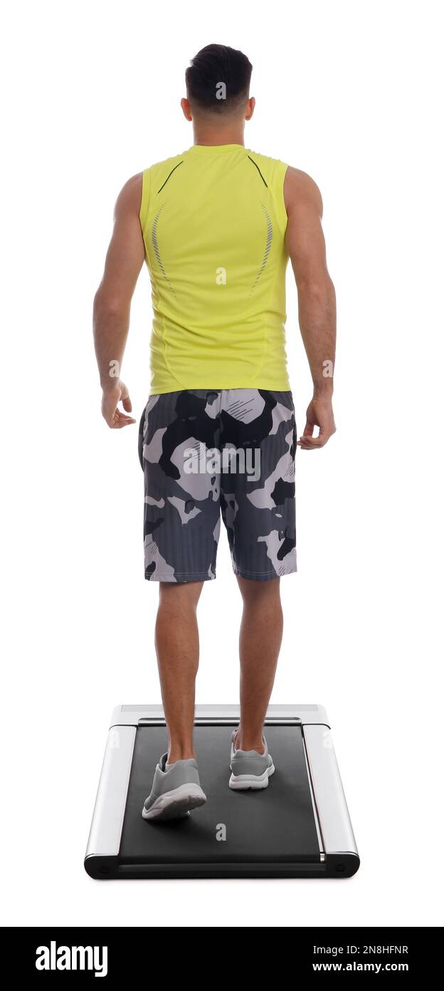 Sporty man using walking treadmill on white background, back view Stock ...