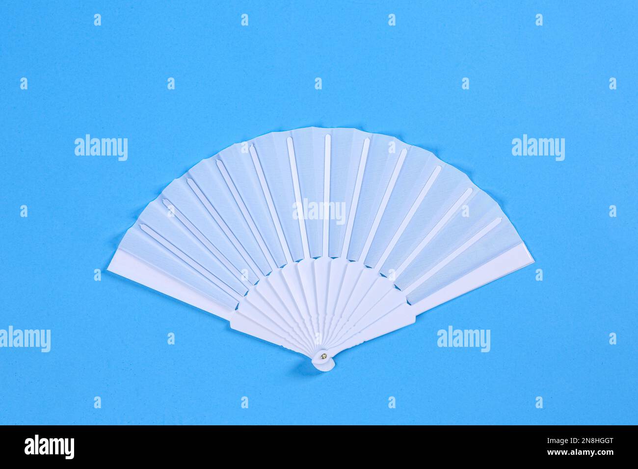 White hand fan on light blue background, top view Stock Photo - Alamy