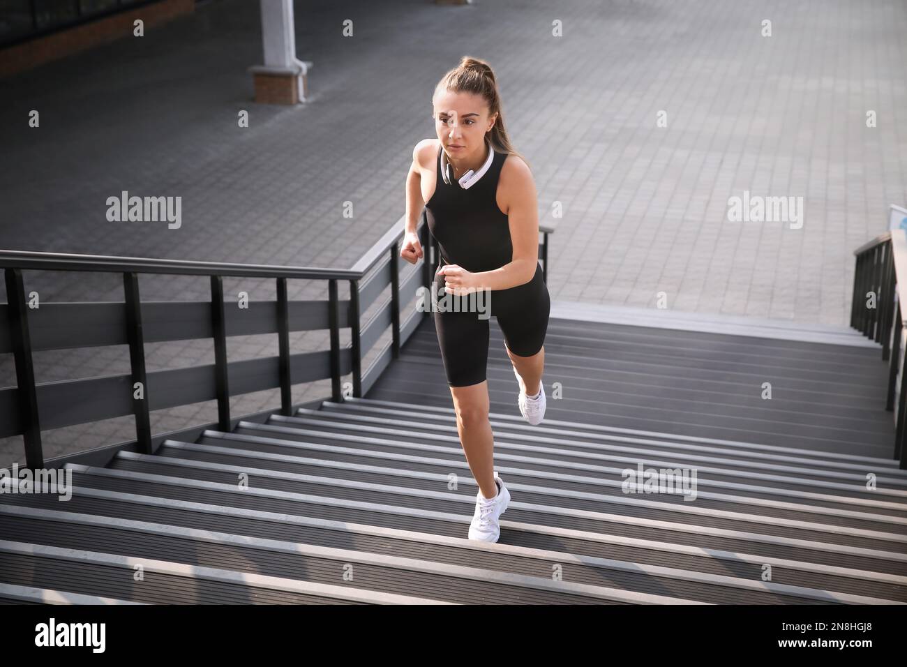 Black woman running up stairs hi-res stock photography and images - Alamy