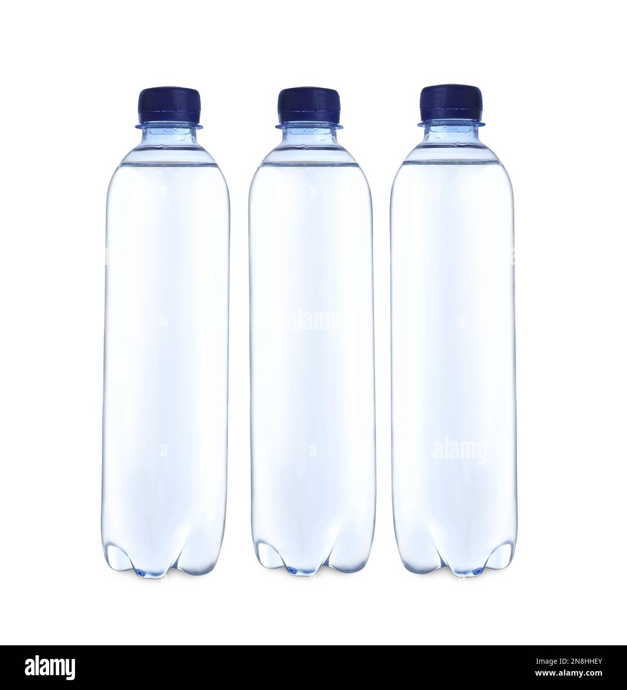 Plastic bottles with water on table against white background Stock ...