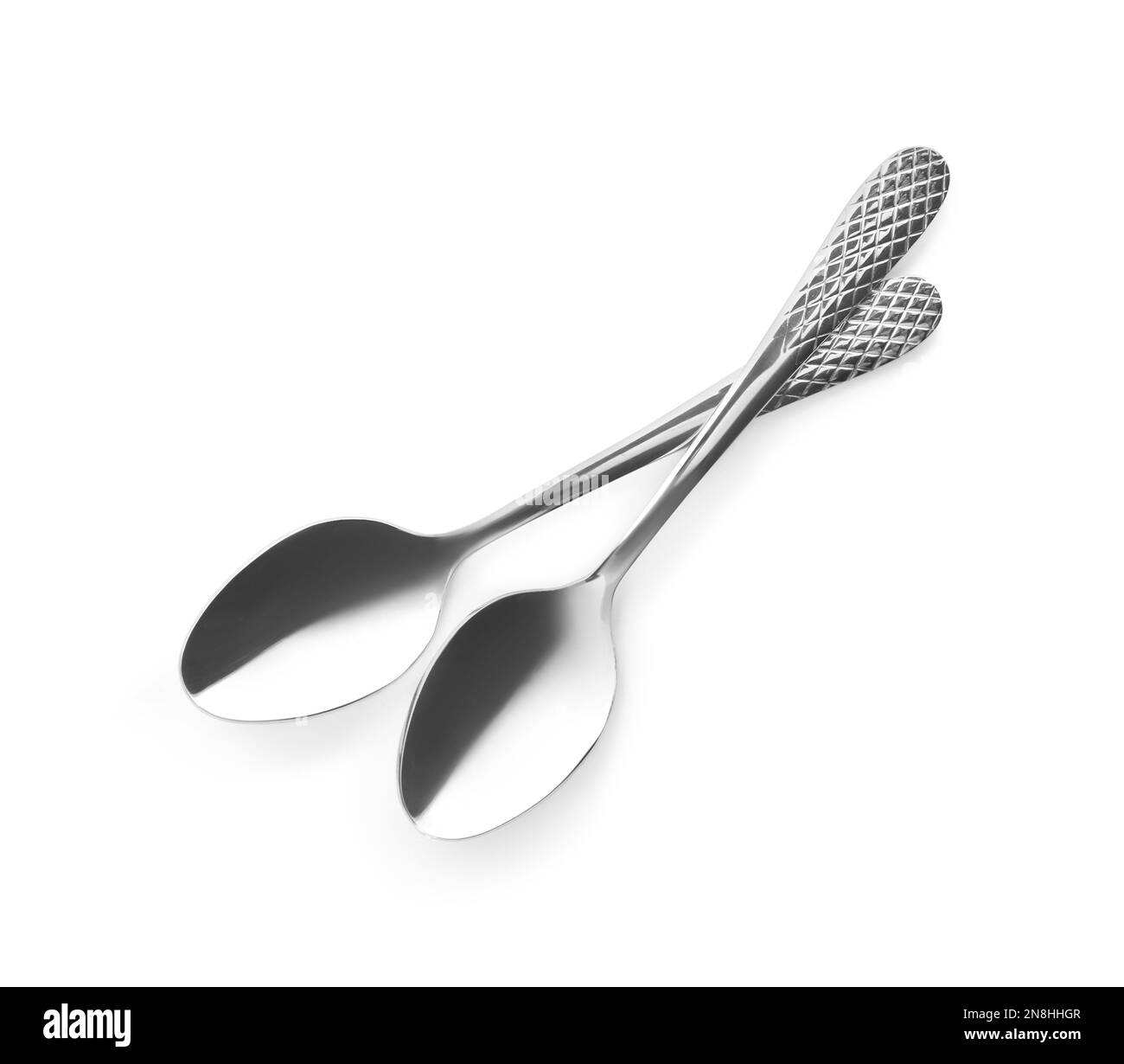 Clean shiny metal spoons on white background Stock Photo - Alamy