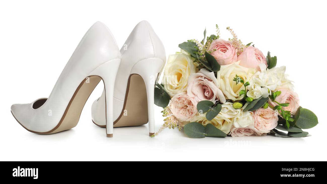 Pair of wedding high heel shoes and beautiful bouquet on white ...