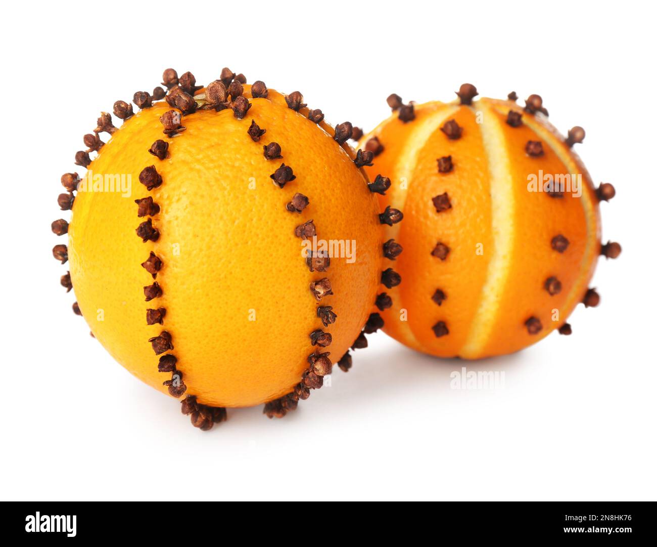 Pomander balls made of fresh oranges and cloves on white background ...