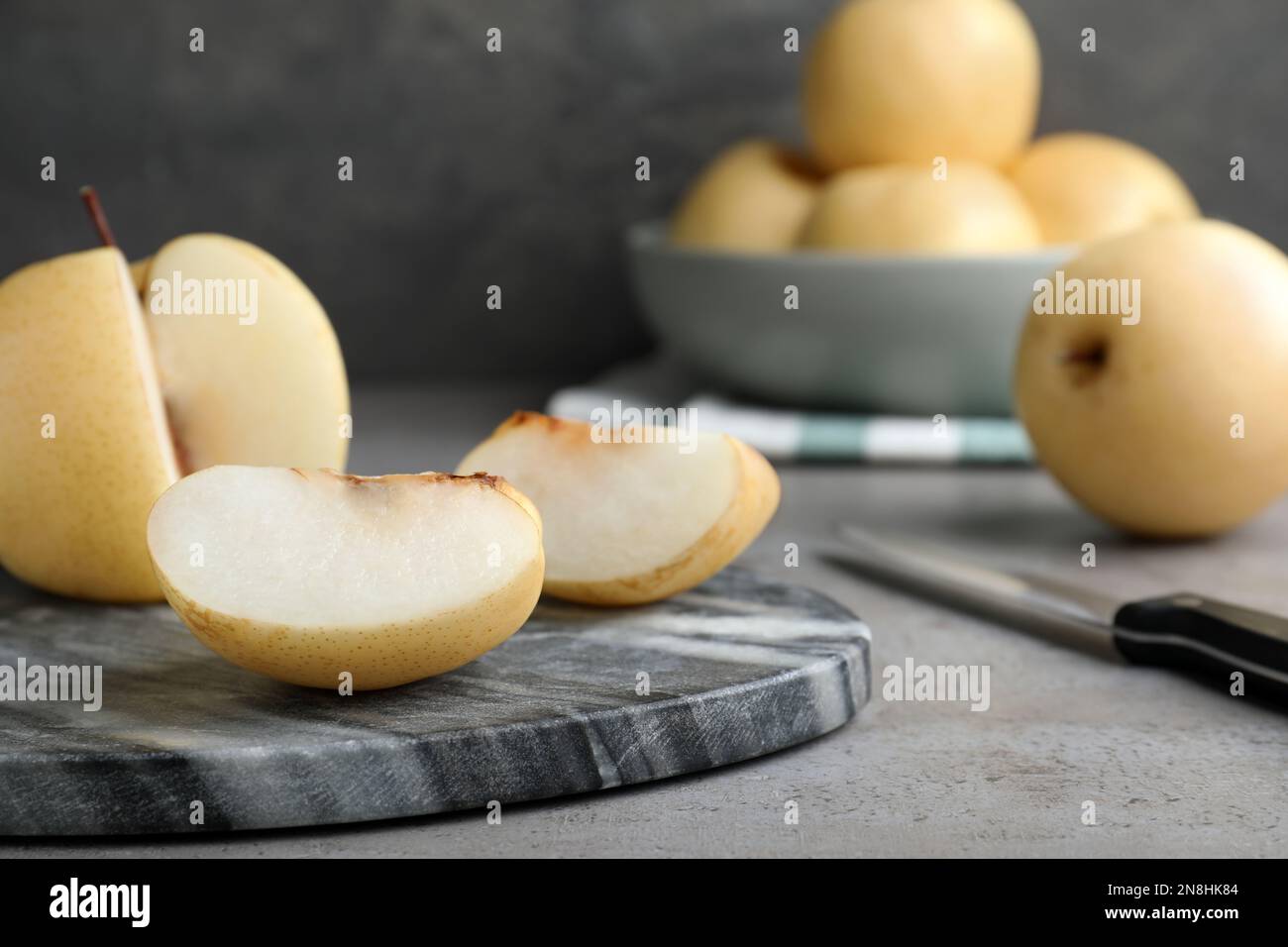 Cut fresh apple pear on grey table Stock Photo - Alamy