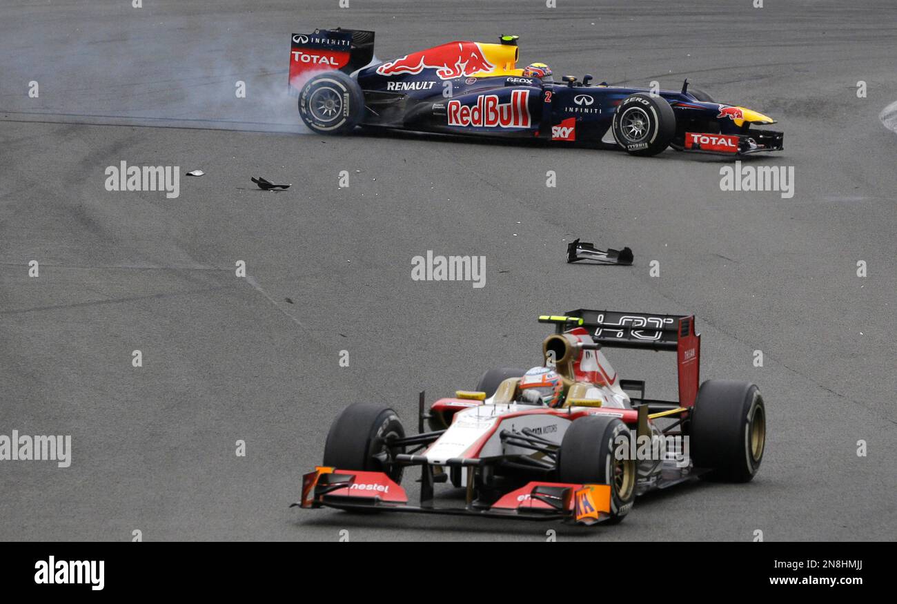 Red Bull driver Mark Webber of Australia, back, steers his car after colliding during the ...