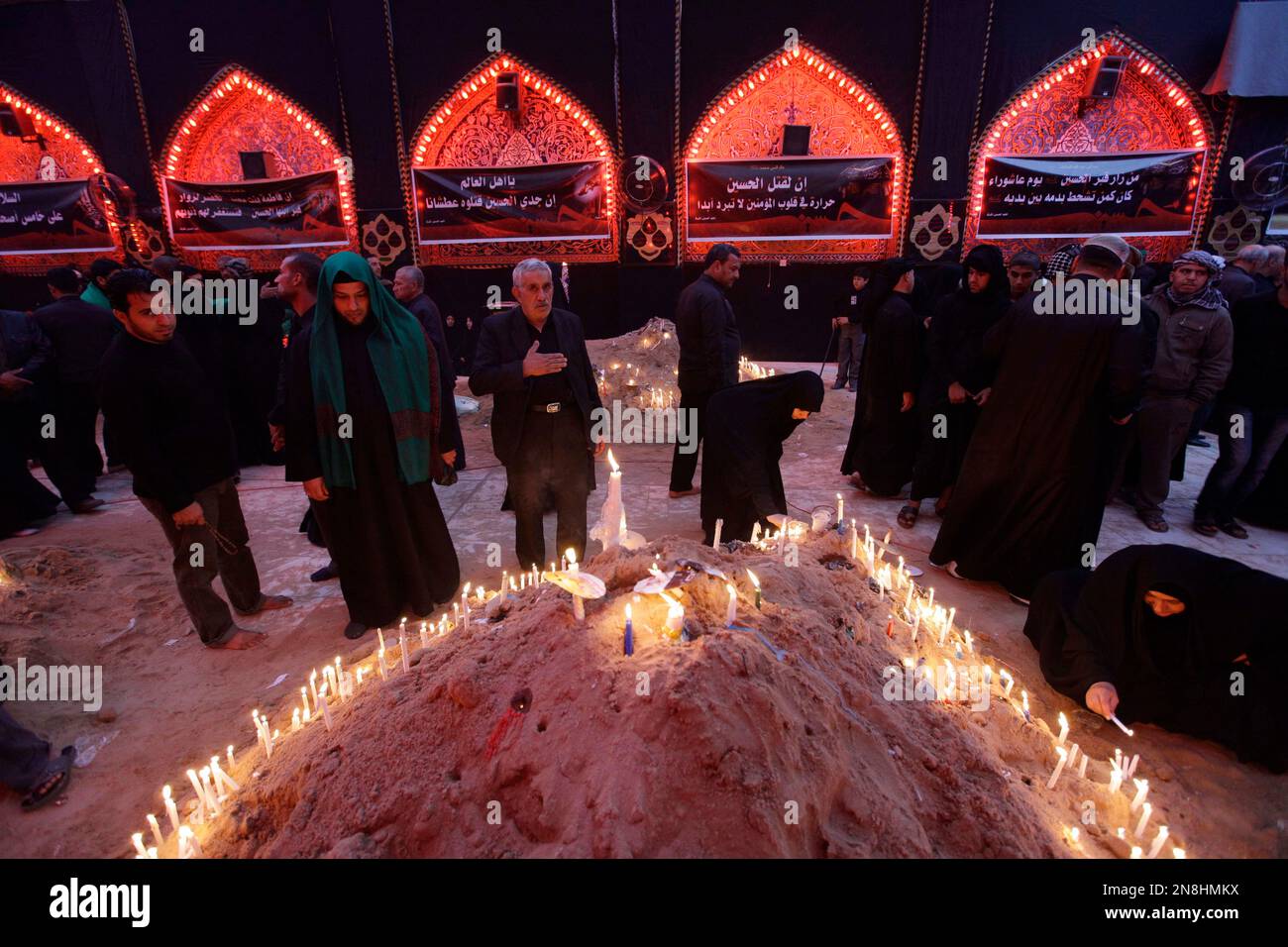 Shiite Muslim worshippers light candles to mark the Muslim festival of ...