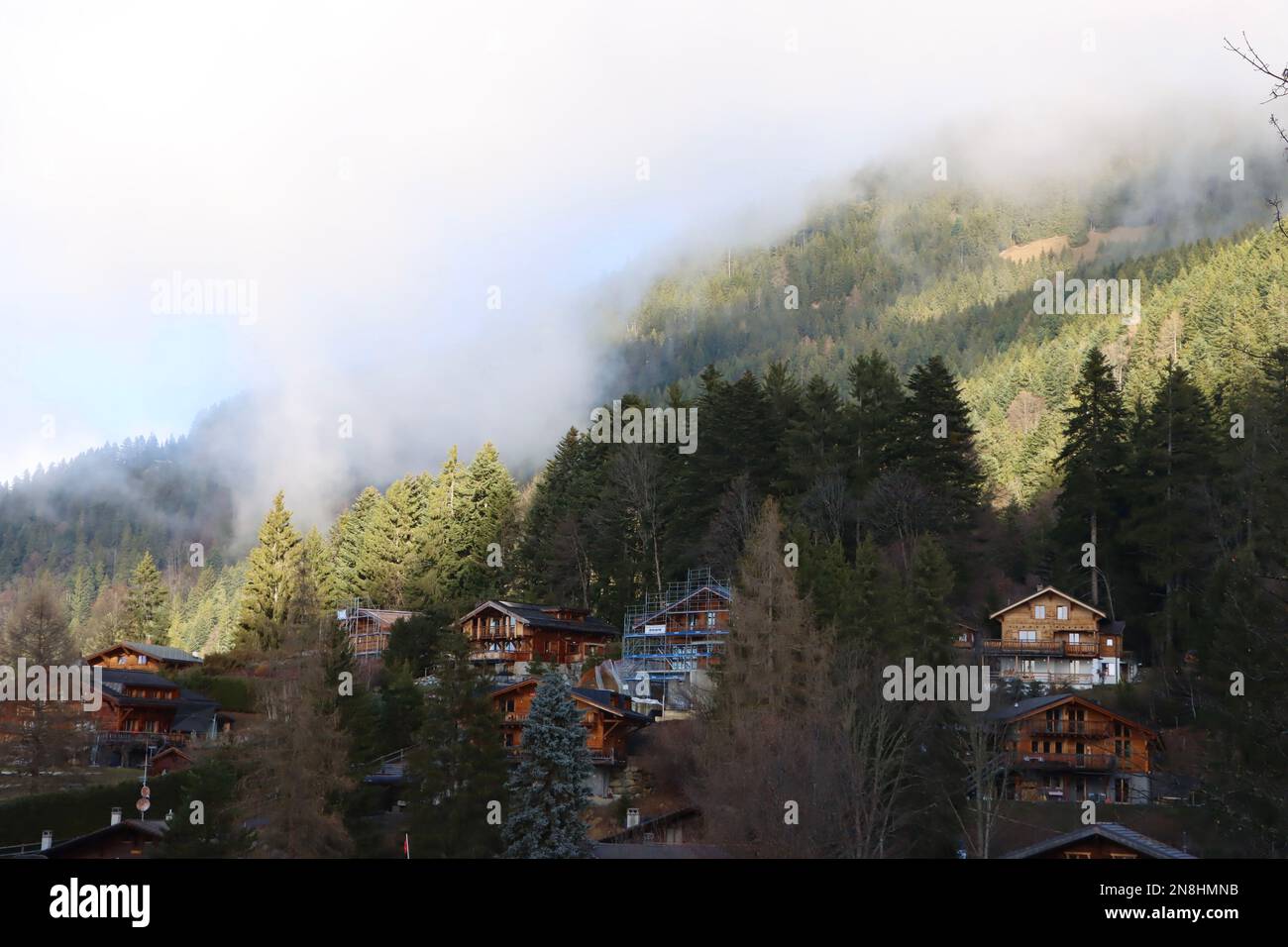 Clouds of fog over the mountainside and forest over Les Ecovets ...