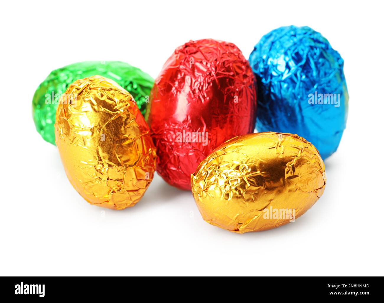 Chocolate eggs wrapped in bright foil on white background Stock Photo ...