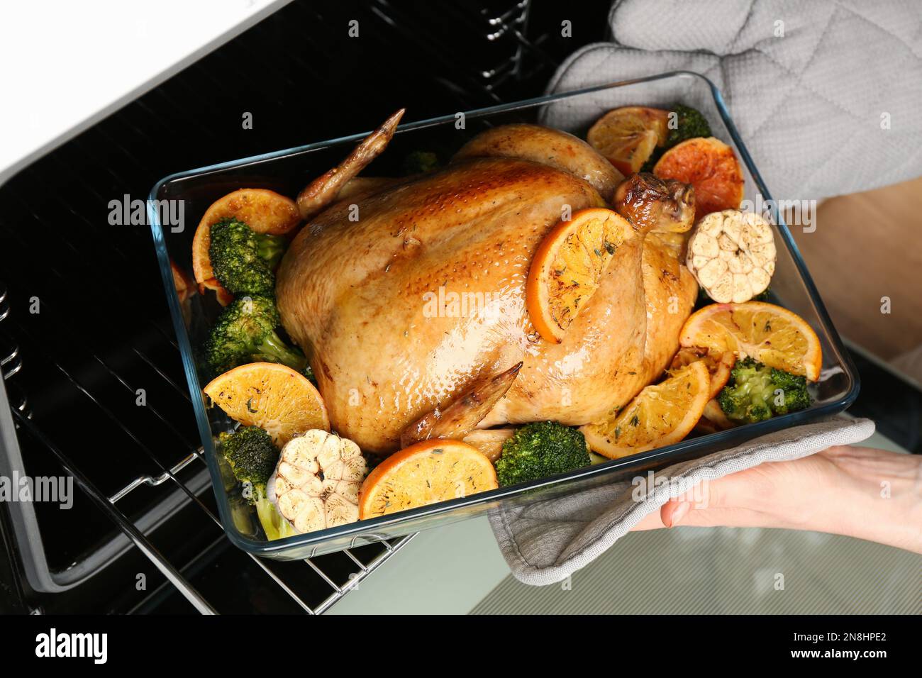 Woman taking baked chicken hi-res stock photography and images - Alamy