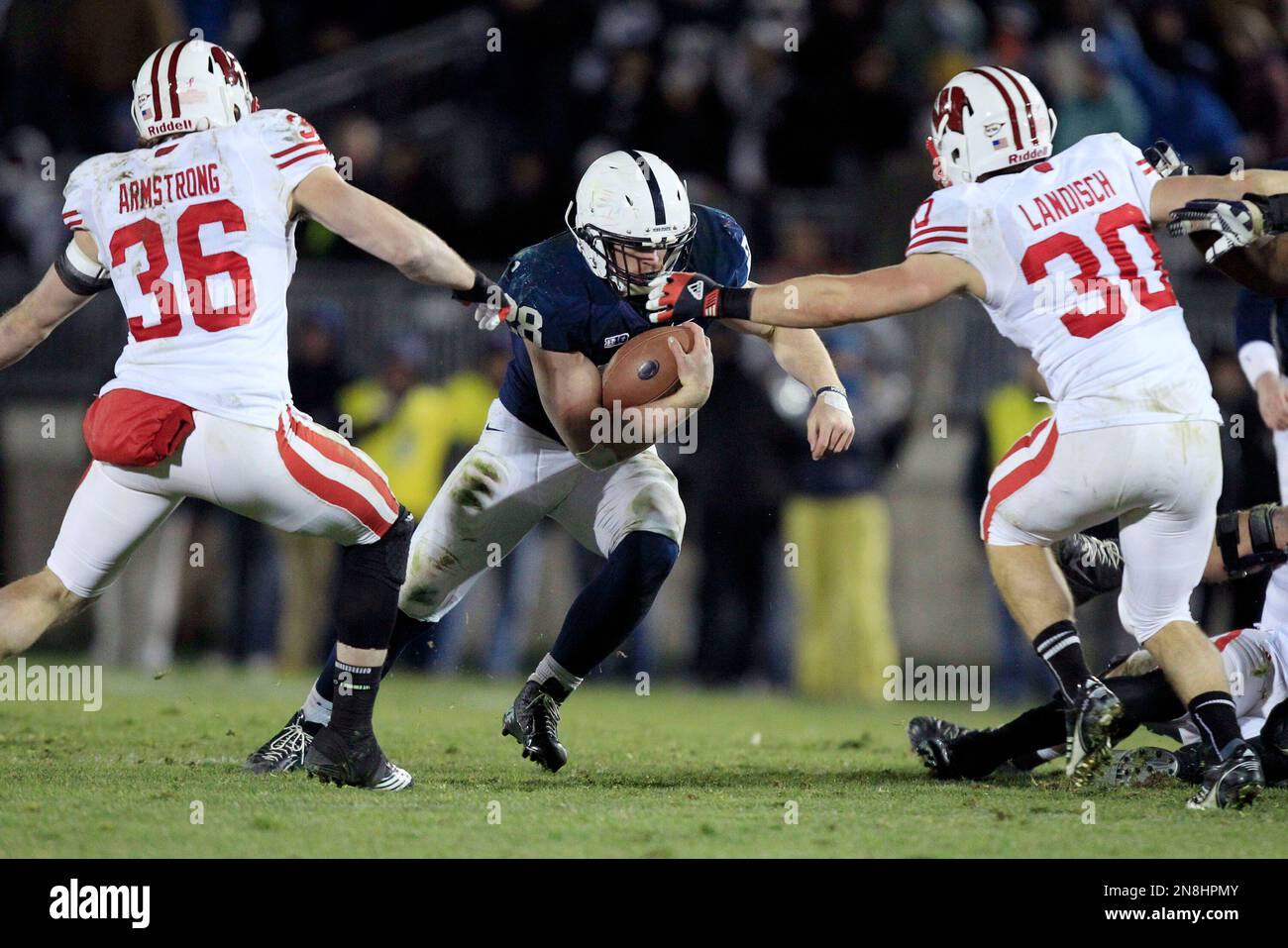 Penn State running back Zach Zwinak (28) runs between Wisconsin ...