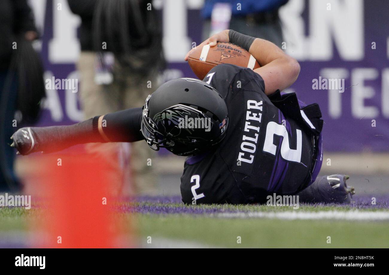 Northwestern quarterback Kain Colter (2) scores a touchdown during the ...