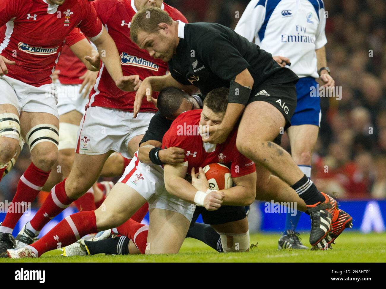 Wales' Scott Williams, centre, is tackled by New Zealand's Owen Franks ...