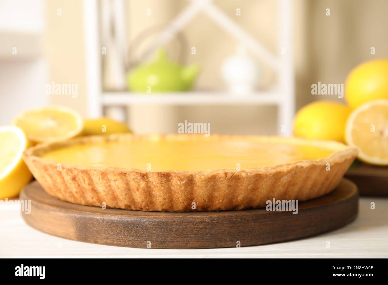 Delicious homemade lemon pie on white wooden table, space for text ...
