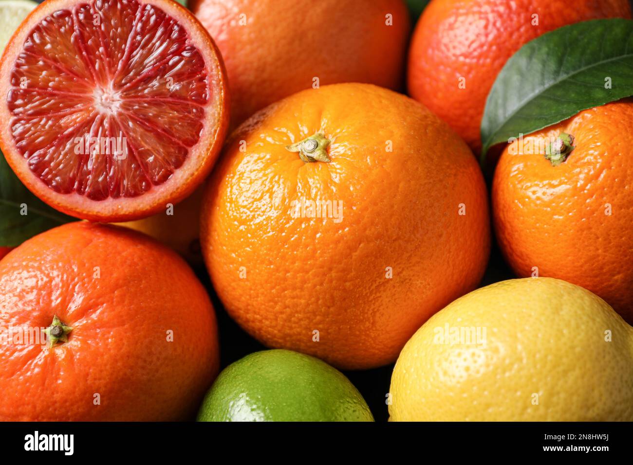 Different ripe citrus fruits as background, closeup Stock Photo - Alamy