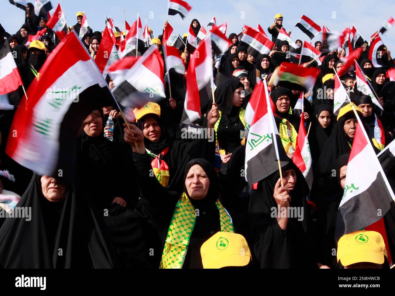 Supporters of the Supreme Islamic Iraqi Council wave Iraqi national ...