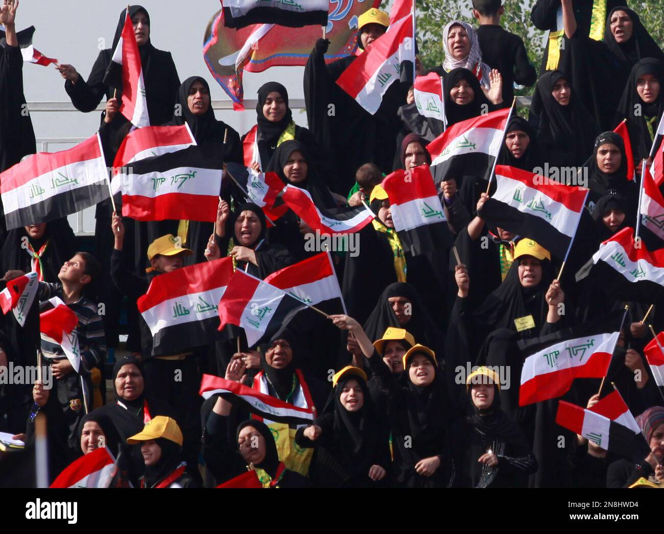 Supporters of the Supreme Islamic Iraqi Council wave Iraqi national ...