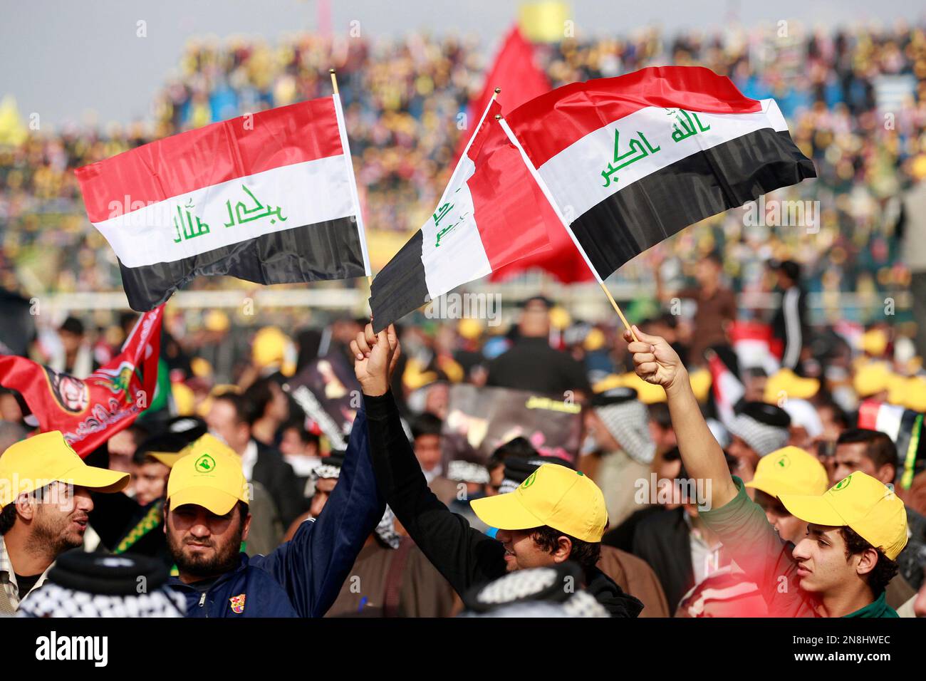 Supporters of the Supreme Islamic Iraqi Council wave Iraqi national ...