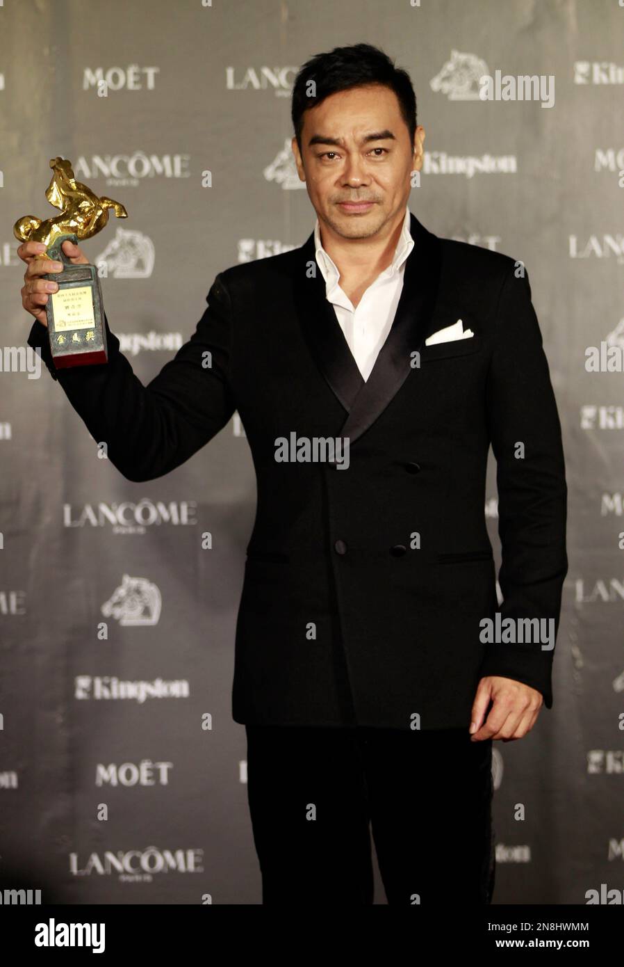 Hong Kong actor Lau ChingWan hold his award for the Best Actor for the ...