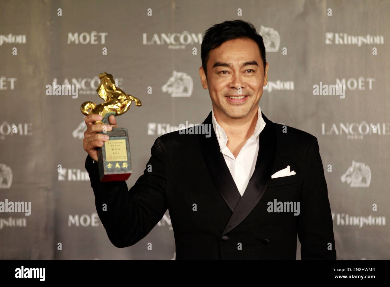 Hong Kong actor Lau ChingWan hold his award for the Best Actor for the ...