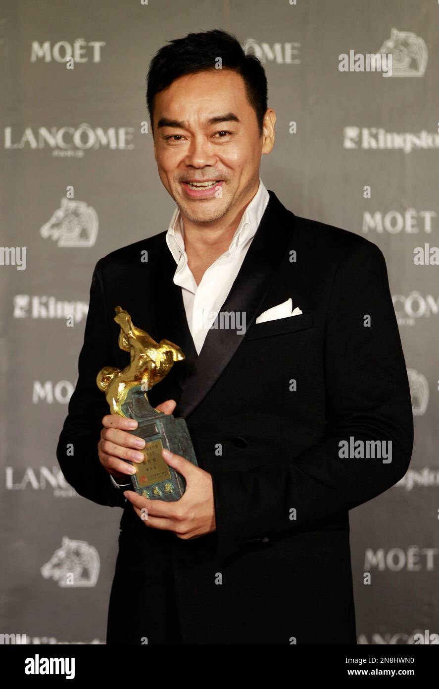 Hong Kong actor Lau ChingWan hold his award for the Best Actor for the ...