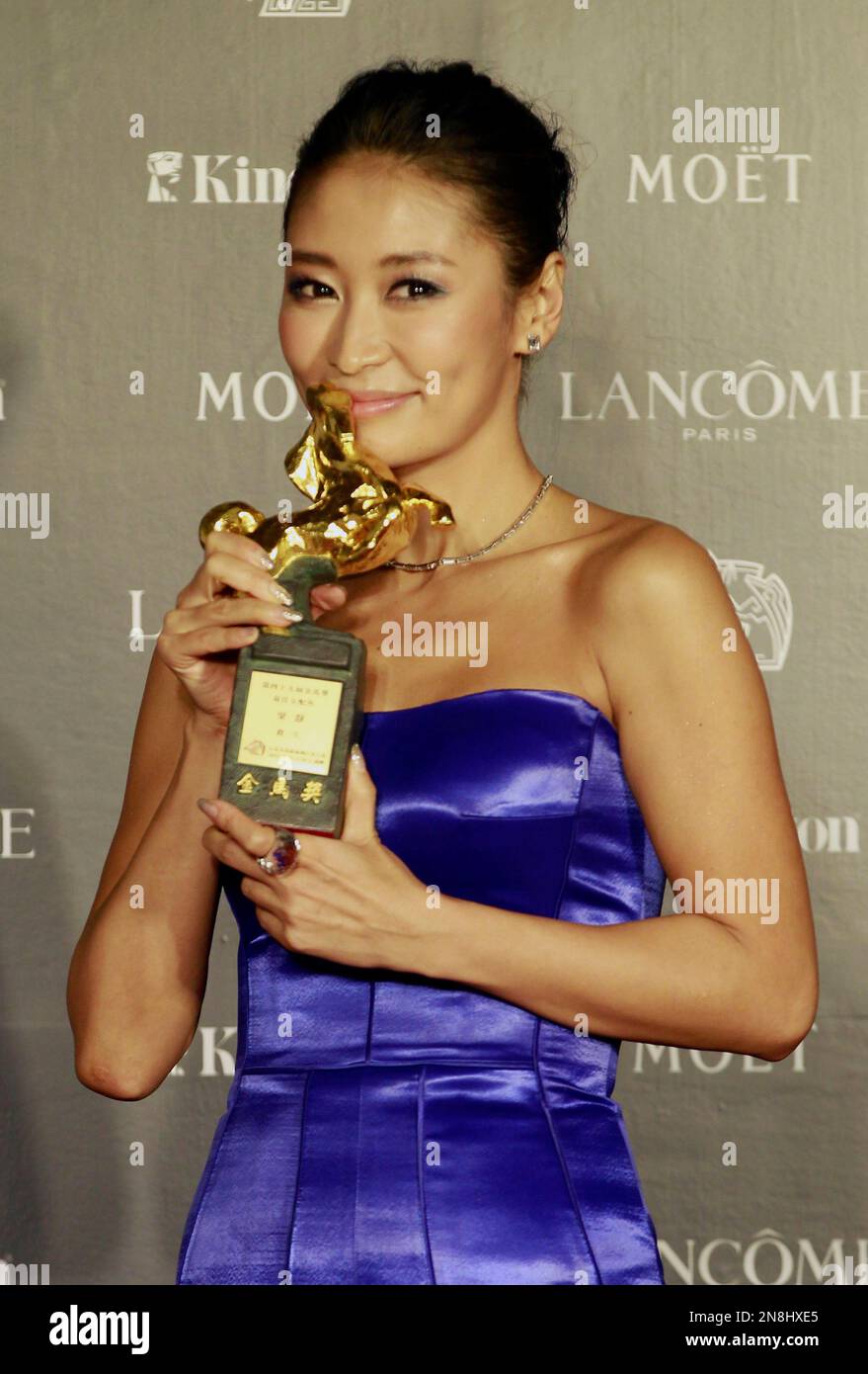 Chinese actress Liang Jing poses for photos with her trophy for the ...