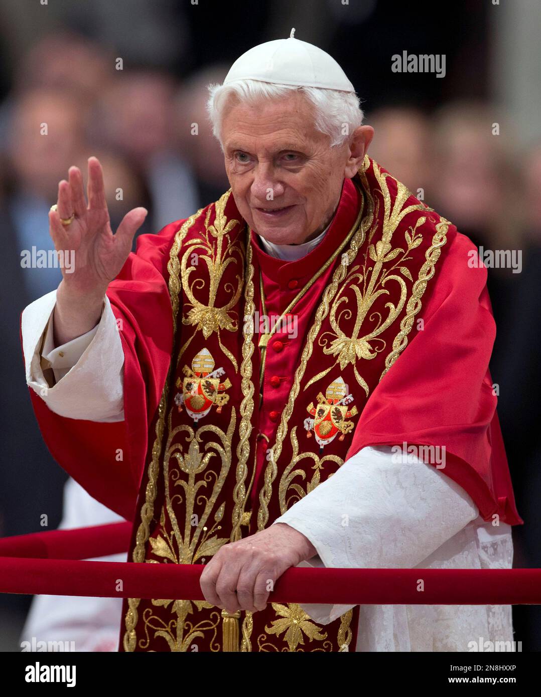 Pope Benedict XVI makes his way through cardinals as he arrives inside ...