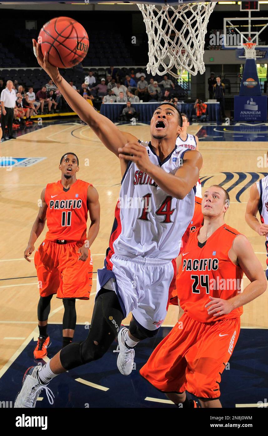 Saint Mary's Stephen Holt, center, goes up for a shot as Pacific's ...
