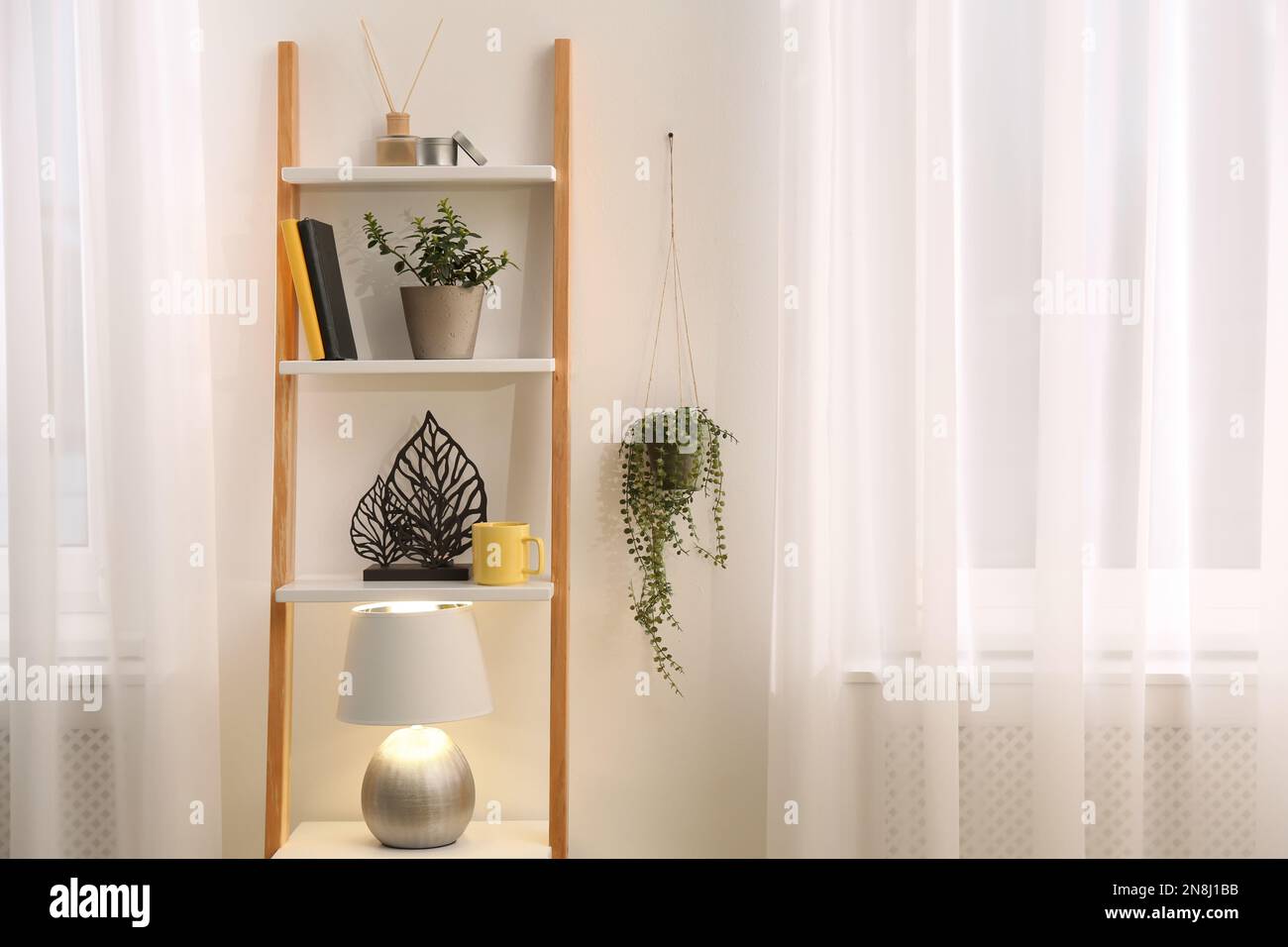 Stylish room interior with wooden ladder near white wall Stock Photo ...