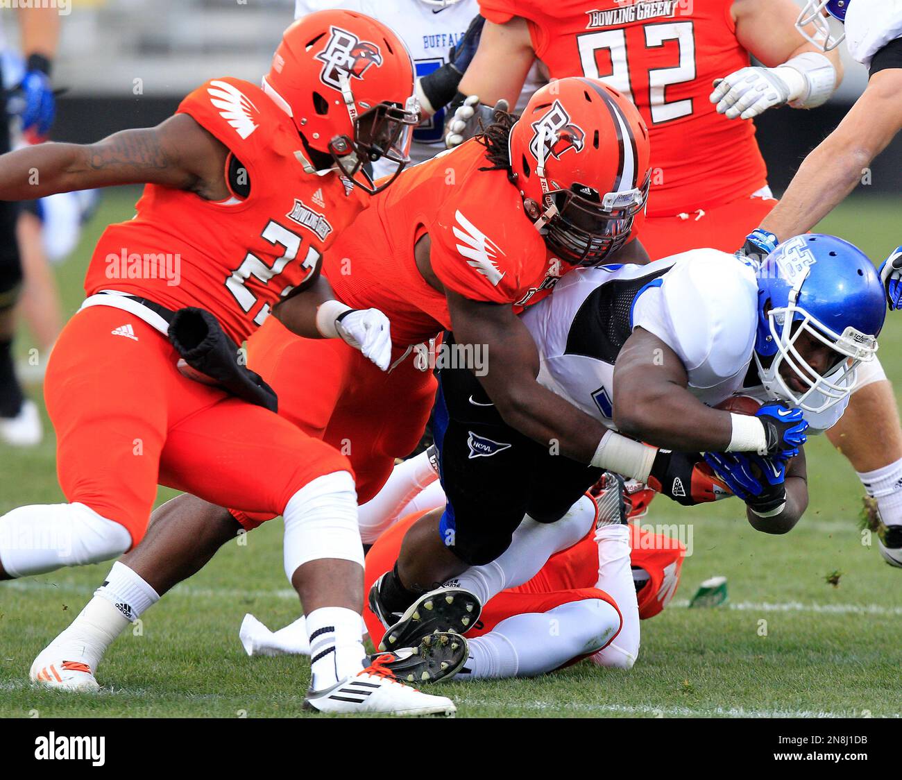 Buffalo running back Branden Oliver, right, is tackled by Bowling Green ...