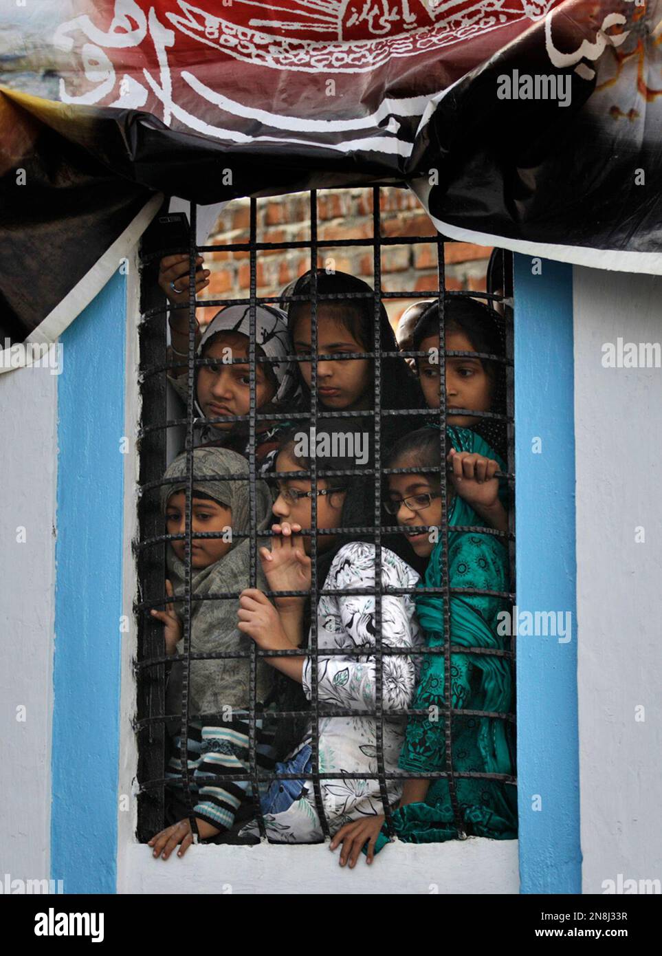 Indian Muslim Shiite girls watch a procession to mark Muharram in ...