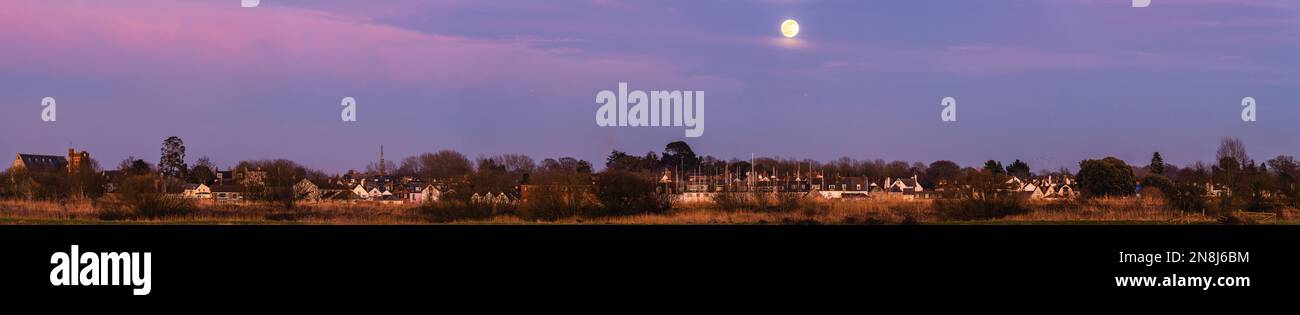 The rising moon at sunset over marshes, Topsham, Devon, England, Europe ...
