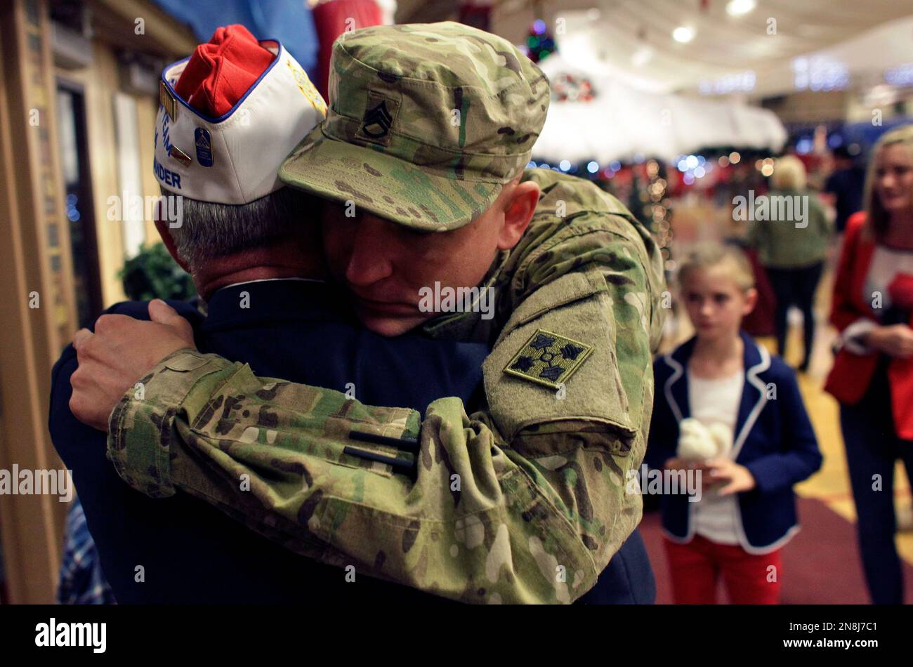 U.S. Army Staff Sgt. Mitchell Liming hugs retired Lt. Col. Charley ...