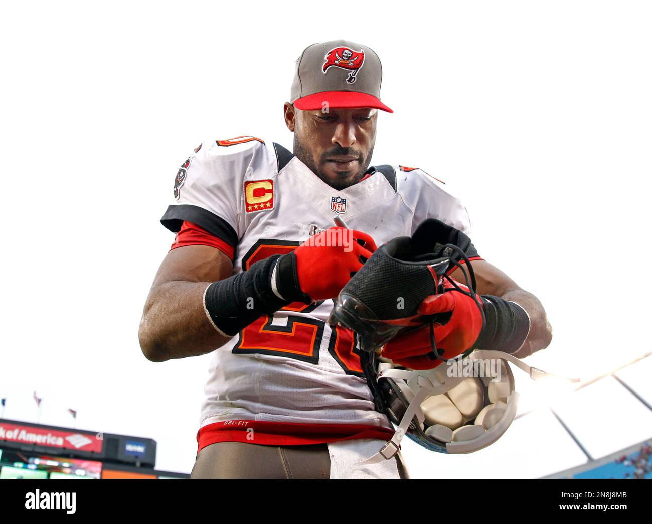 Tampa Bay Buccaneers' Ronde Barber (20) signs one of his game shoes for ...