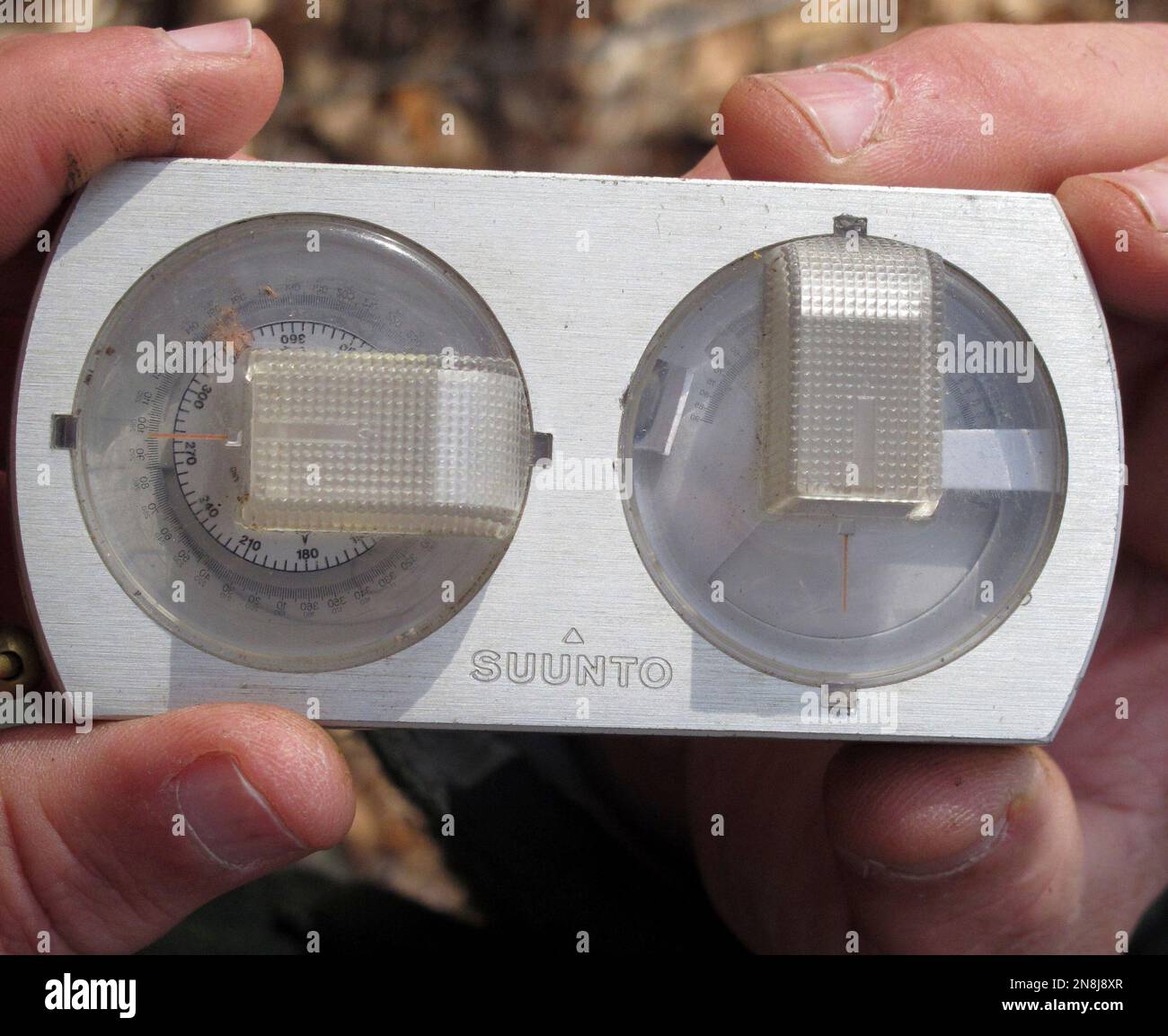 Maine Forest Service forester Merle Ring holds a clinometer, an ...