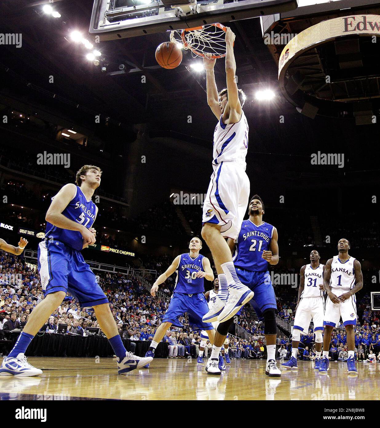 Kansas center Jeff Withey (5) dunks during the first half of an NCAA ...