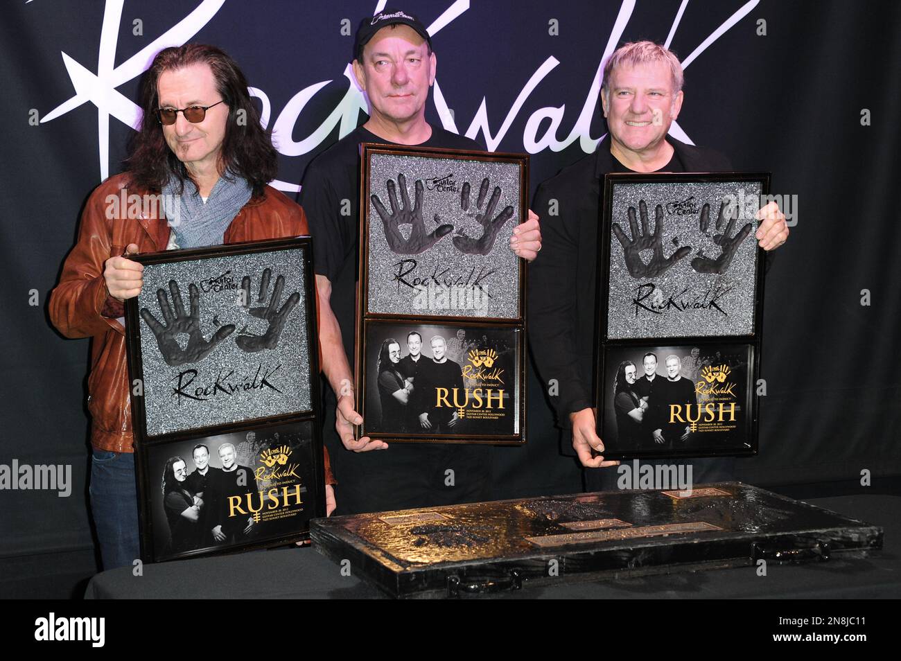 From left, Geddy Lee, Neil Peart, and Alex Lifeson attend the RockWalk induction of Rush at ...