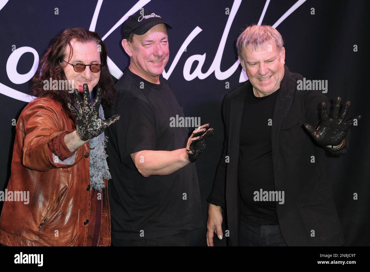 From left, Geddy Lee, Neil Peart, and Alex Lifeson attend the RockWalk ...