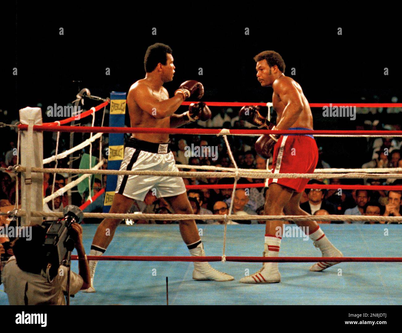 Muhammad Ali, left, during fight with George Foreman, red shorts, in ...