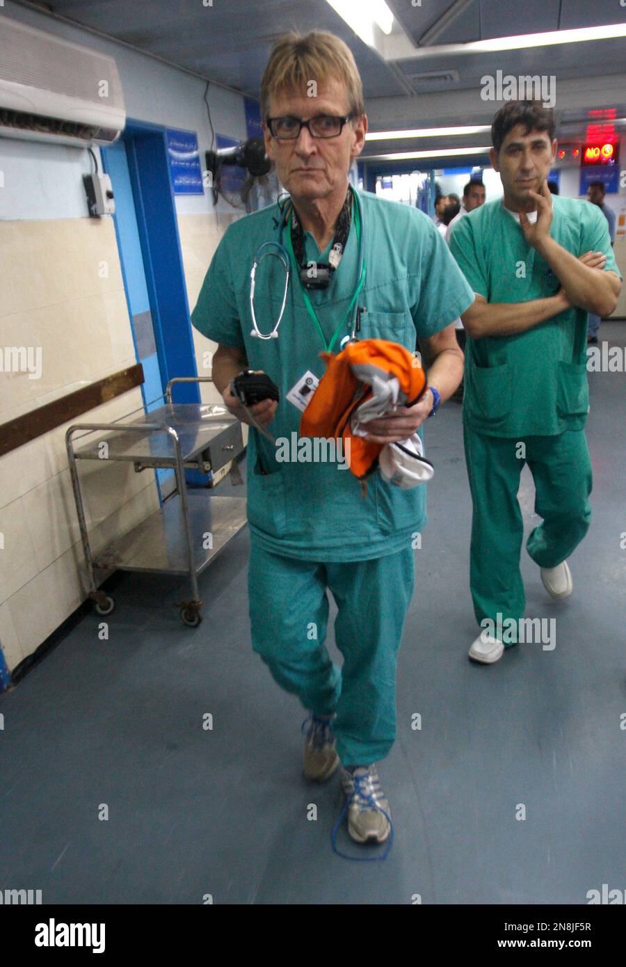 Norwegian doctor Mads Gilbert, who works in Shifa Hospital, walks ...