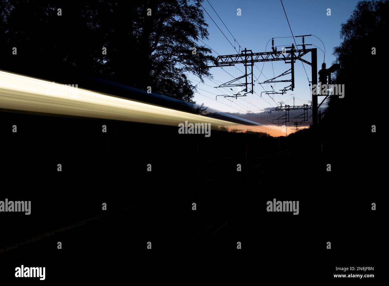 ScotRail Train From Edinburgh Speeds Into The Setting Sun, Destination ...