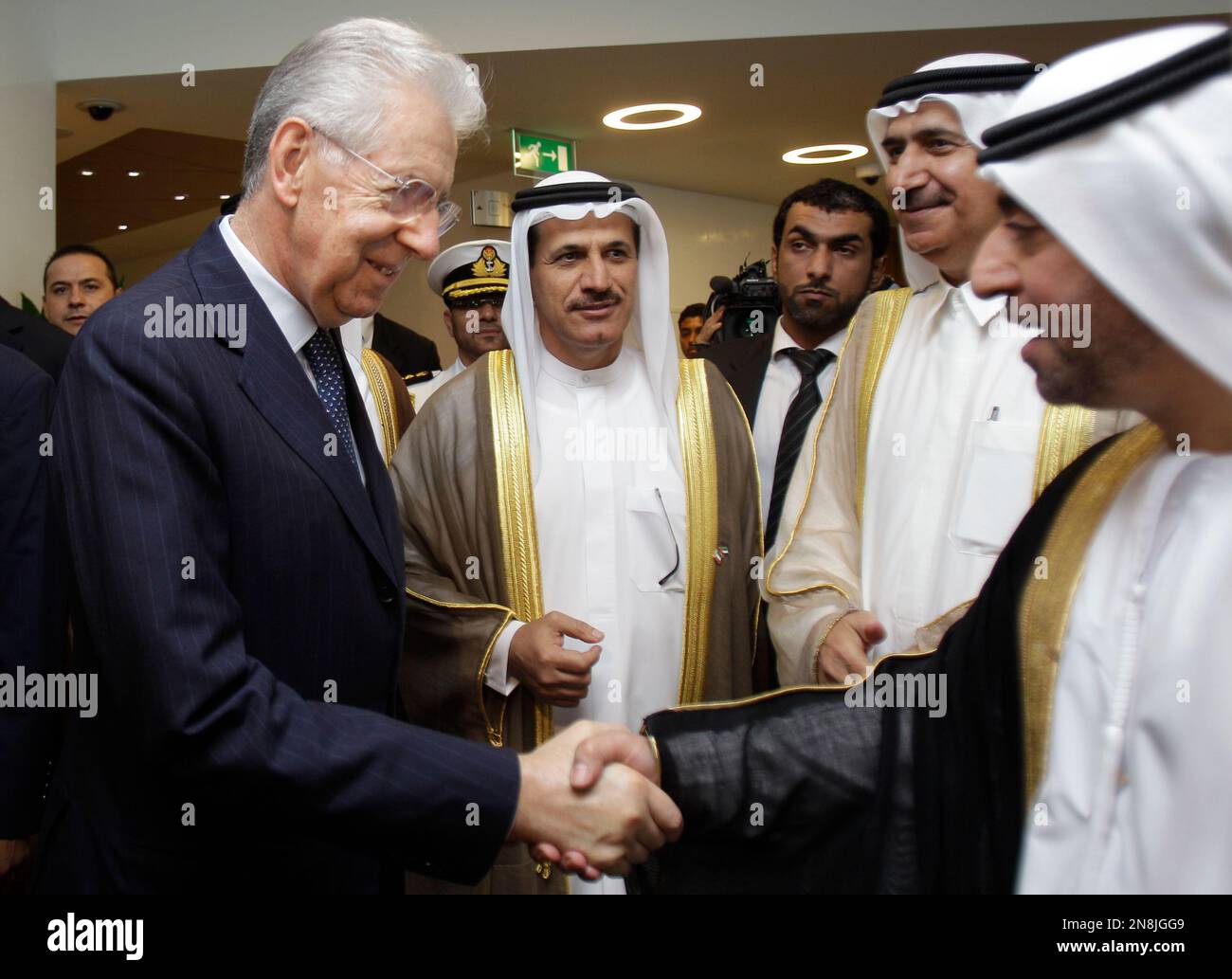 Italian prime minister Mario Monti, left, shakes hands with a UAE ...