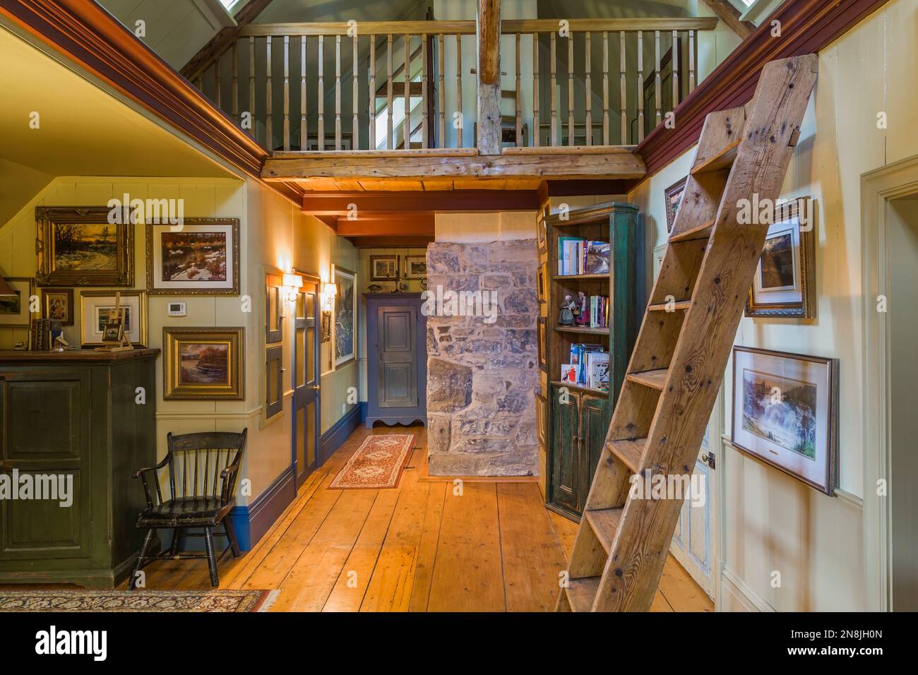 Hallway with wide pinewood floorboards, Miller's stairs, bookcase and ...