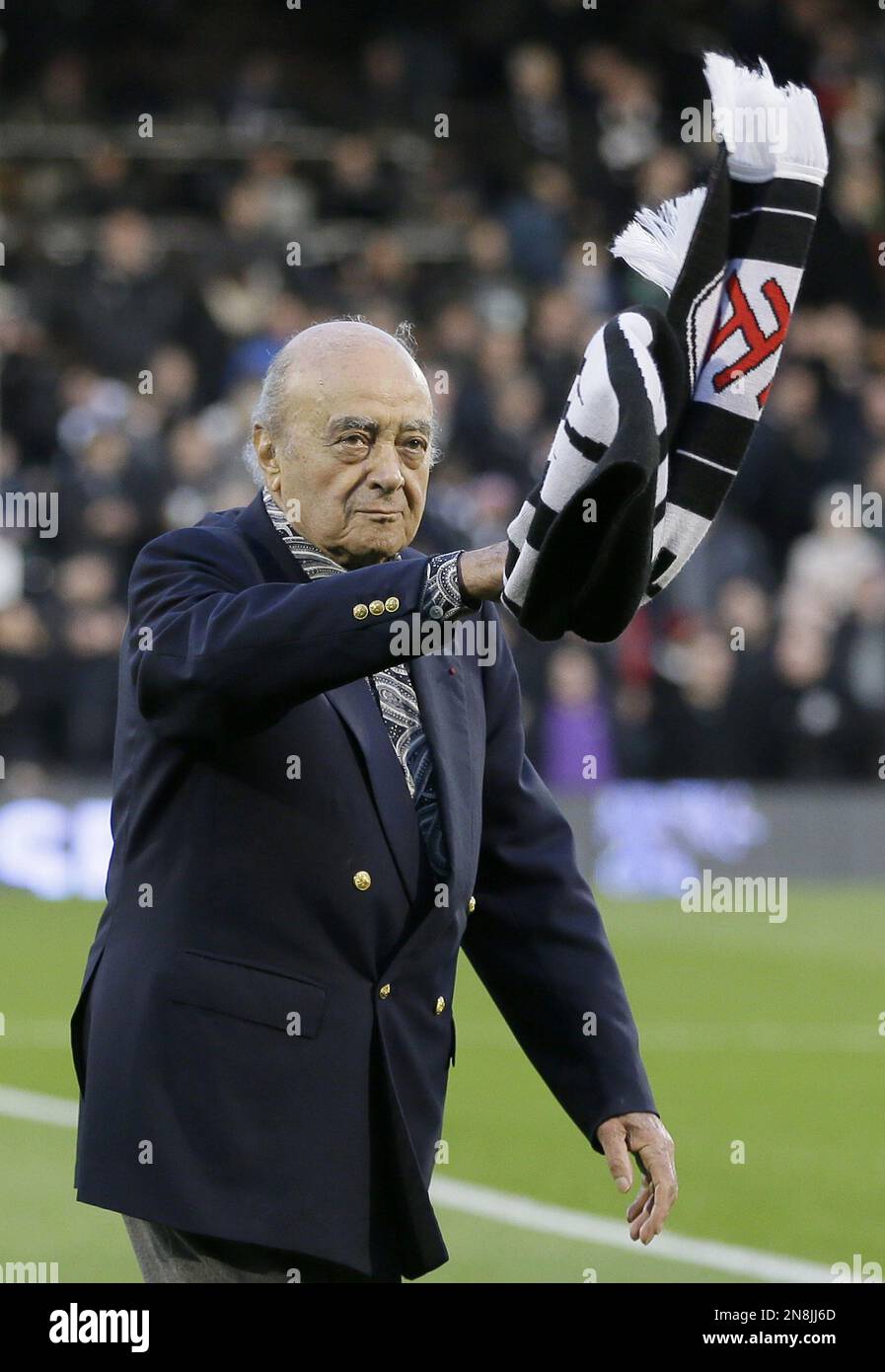 Fulham team owner and club chairman Mohamed Al Fayed waves a club scarf ...