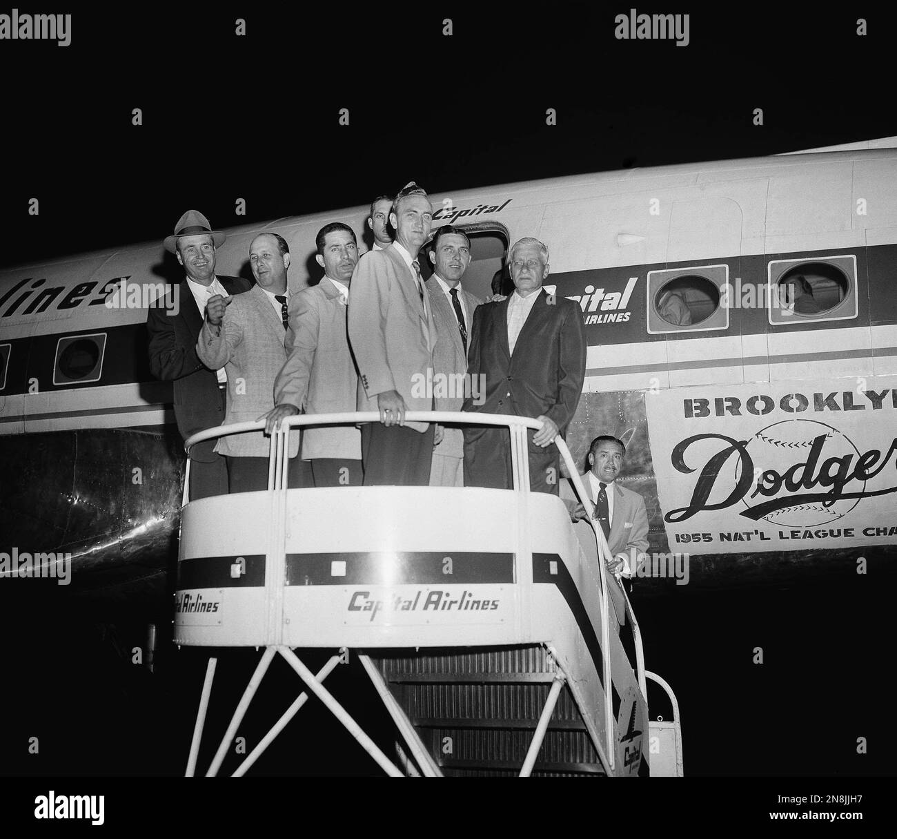 Manager Walt Alston, left, stands on plane ramp with other members of ...