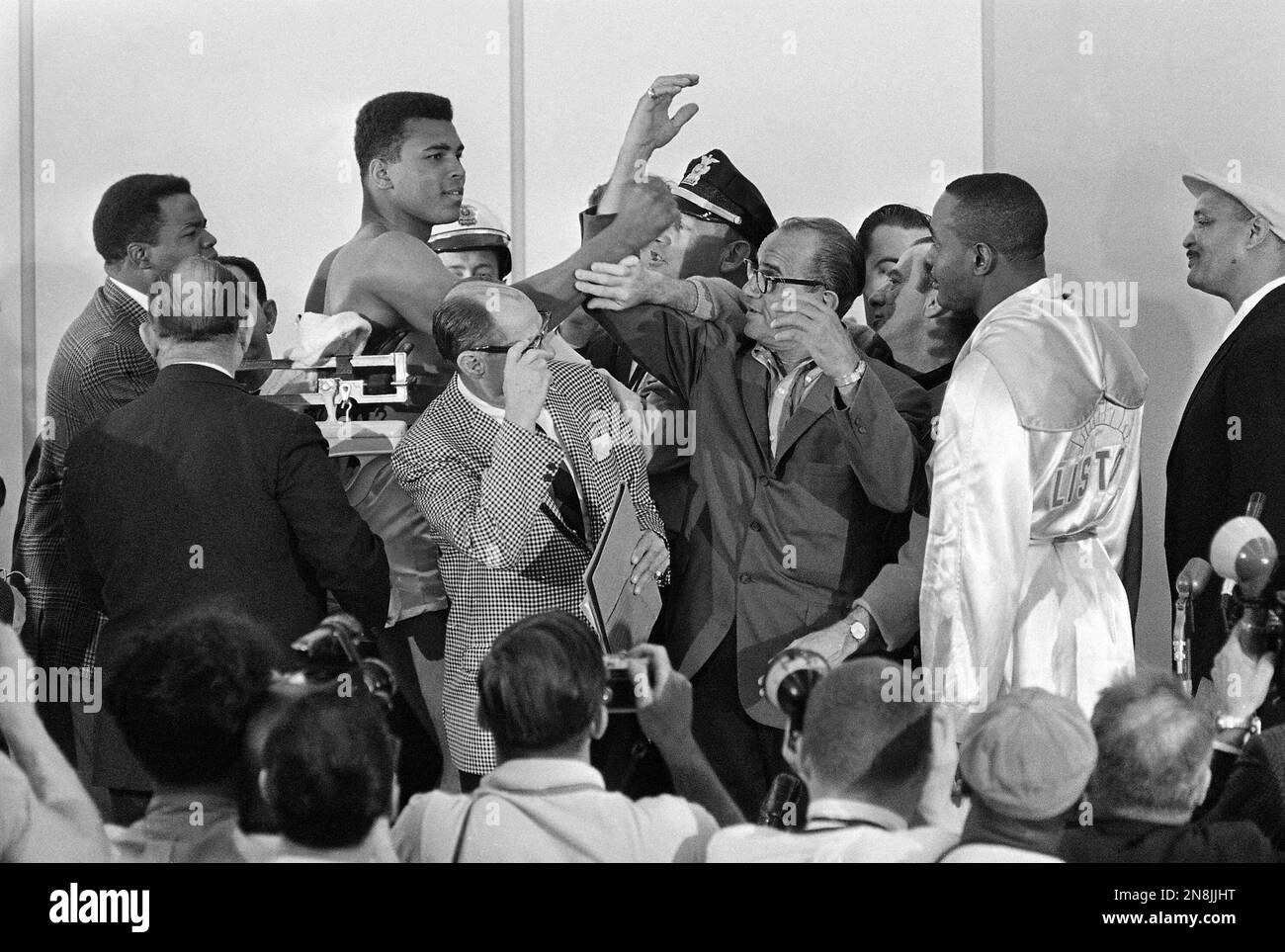 Cassius Clay, left, and Sonny Liston, right, get an early start in fist ...