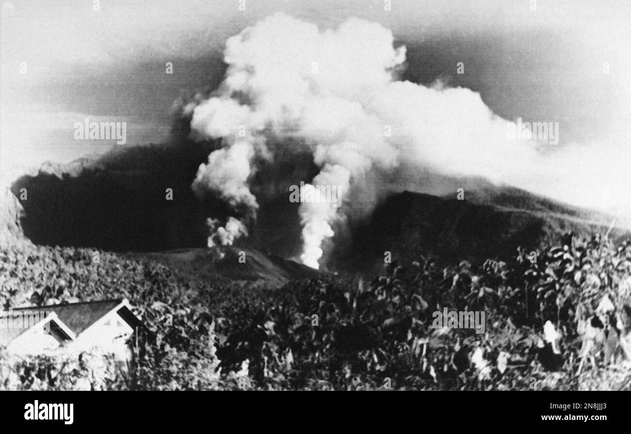 Smoke and ash belch from Jadi mountain at the Galunggung mountain group ...