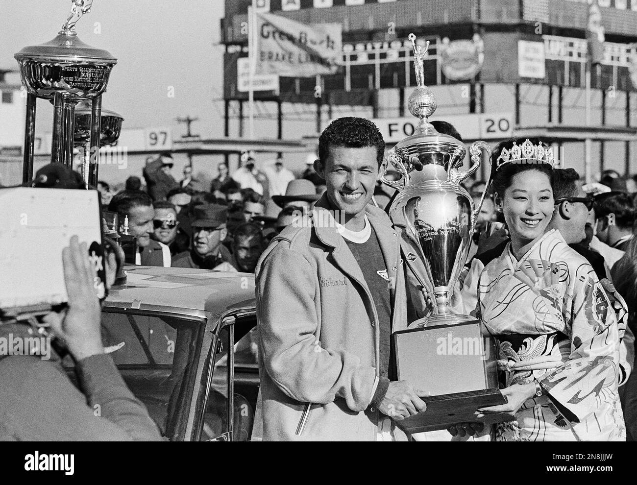 Richard Petty of Randleman, N.C., holds one of the trophies he received ...