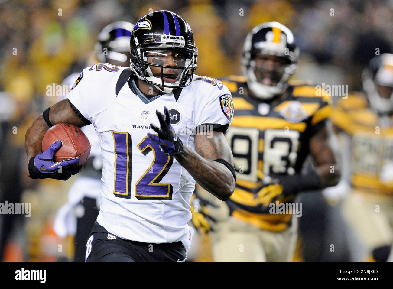 Baltimore Ravens' Jacoby Jones (12) returns a punt past Pittsburgh ...
