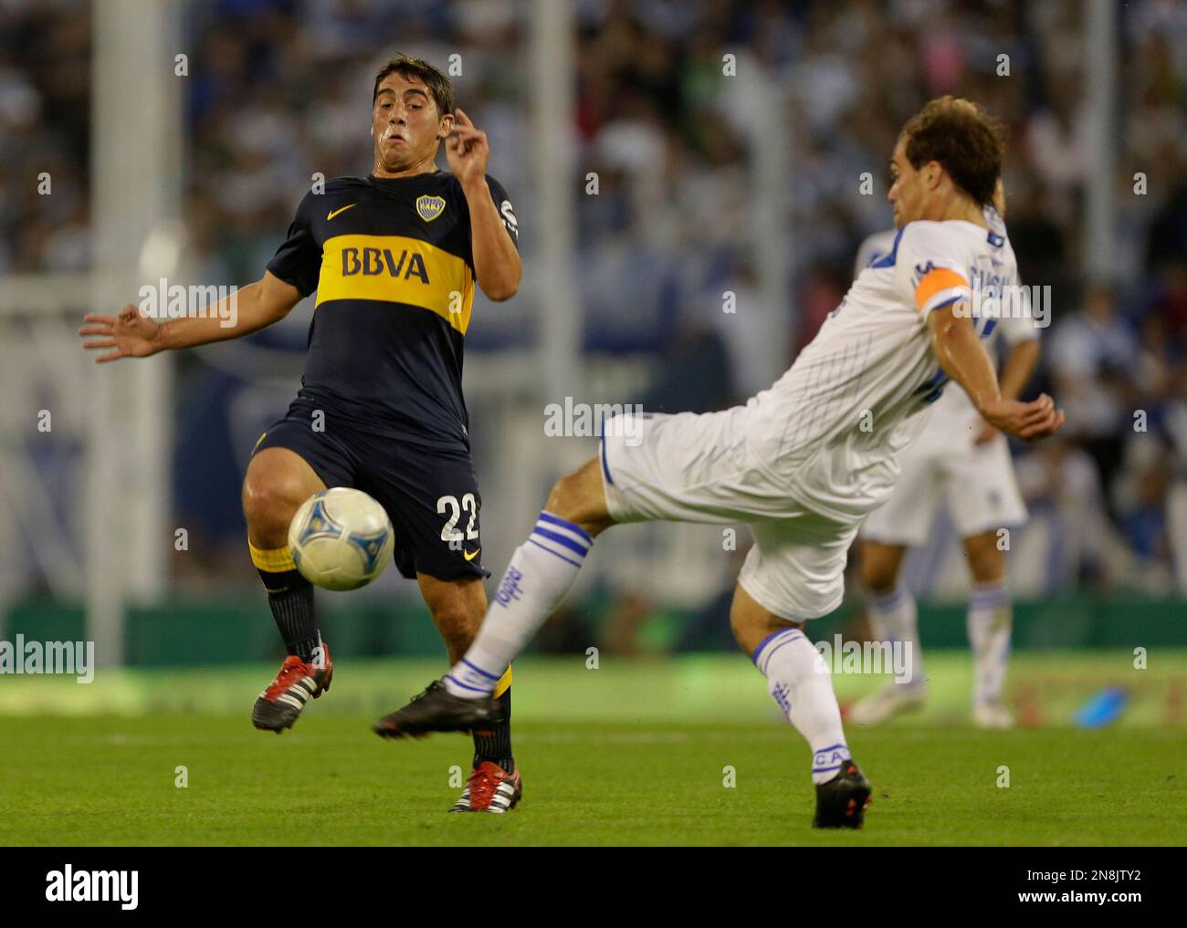 Boca Juniors' Cristian Erbes, left, fights for the ball with Velez ...